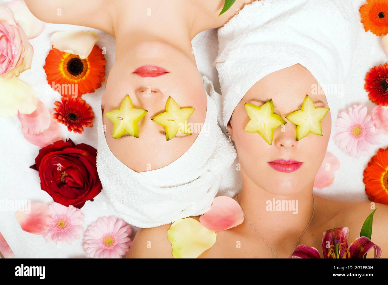 Girls in a beauty treatment with star fruit slices on their eyes Stock ...