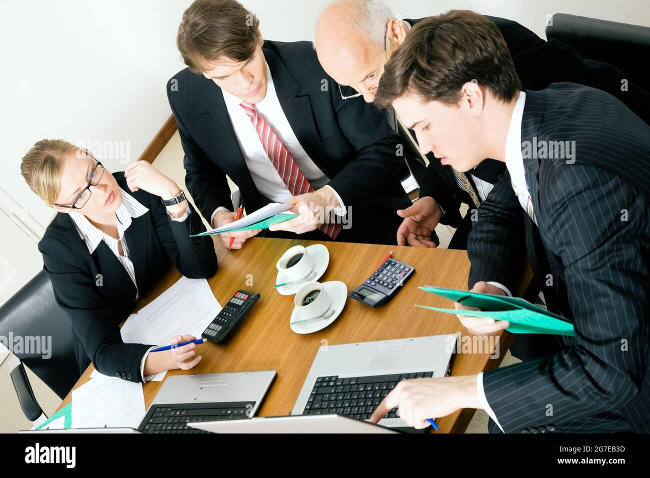 Businesspeople crunching the numbers of a business plan Stock Photo - Alamy