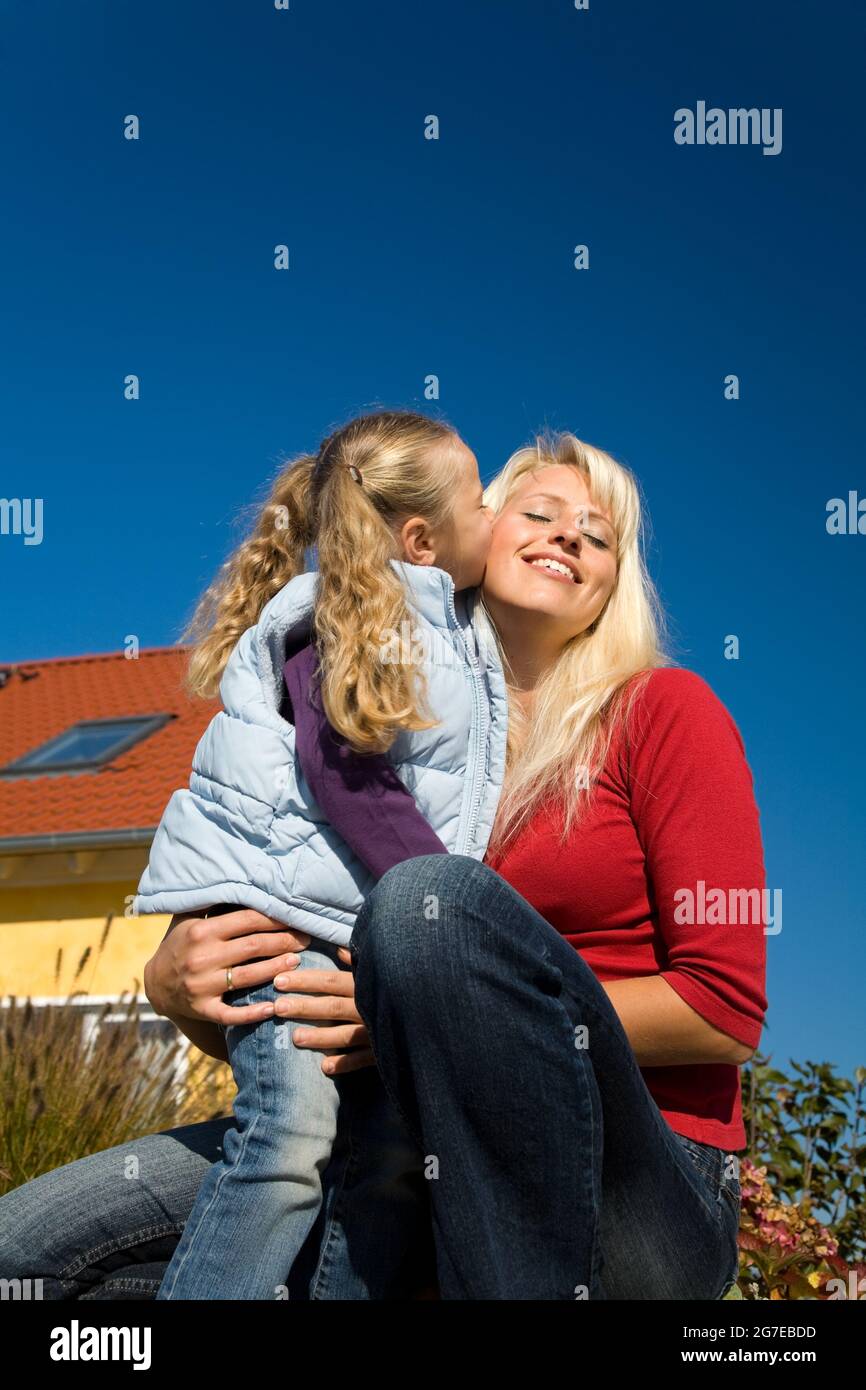 Daughter hugging her mother Stock Photo - Alamy