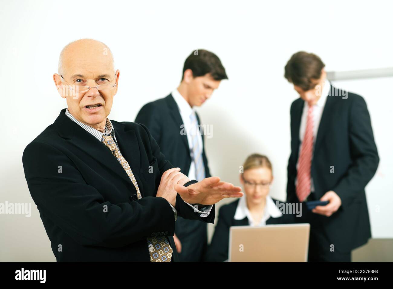 business team with a portrait of the team leader in foreground ...