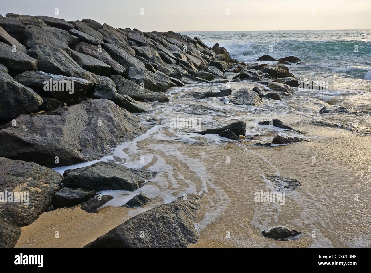 Water splashing in breakwater rocks on the beach Stock Photo - Alamy