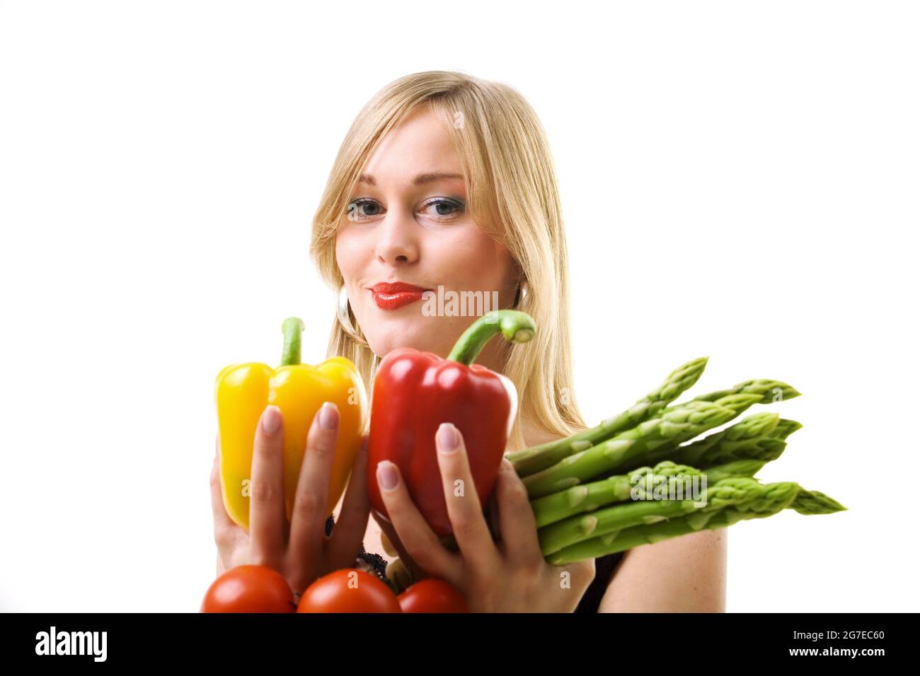 Woman presenting fruit and vegetables to the viewer, metaphor for ...