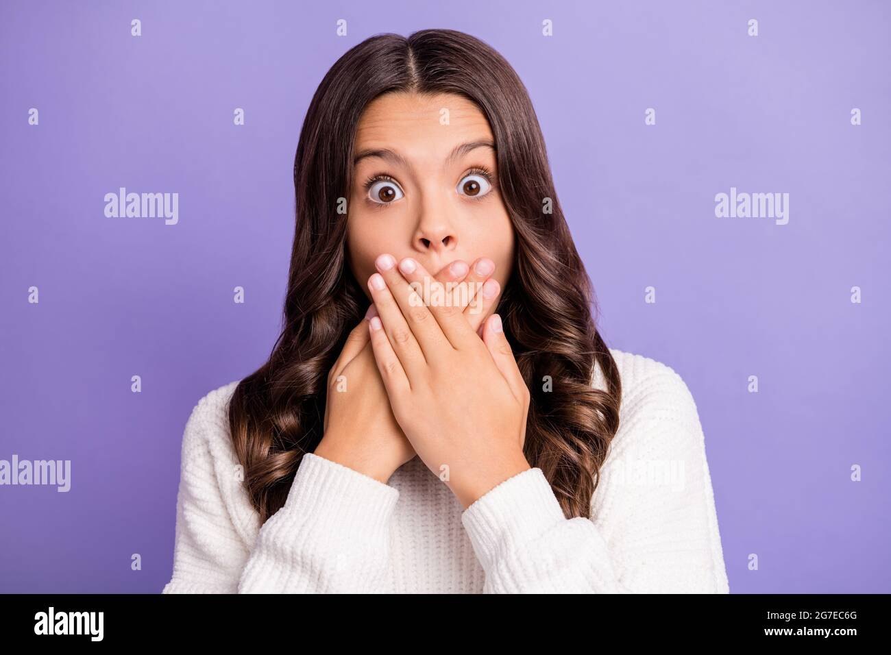 Portrait of young shocked amazed surprised scared afraid girl cover ...