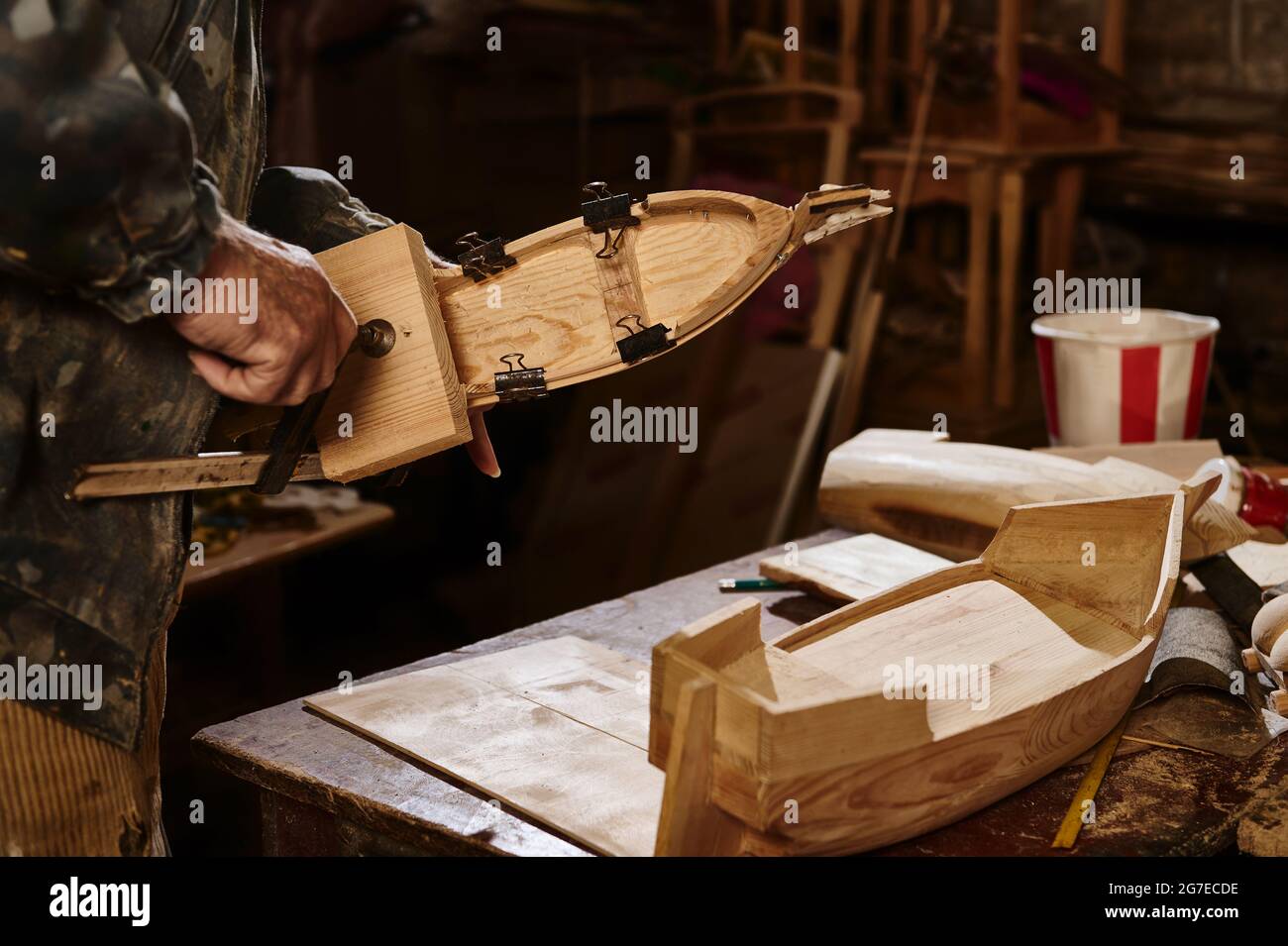 Wooden models of ships on the carpenter's desk against the background ...
