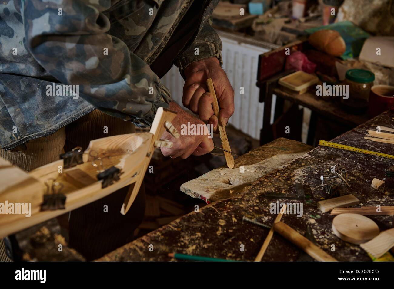 Carpenter using instruments to cut part of wood material to make wooden ...