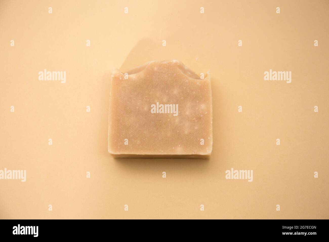 Top view of a handmade bar of eco-friendly soap on a beige surface ...