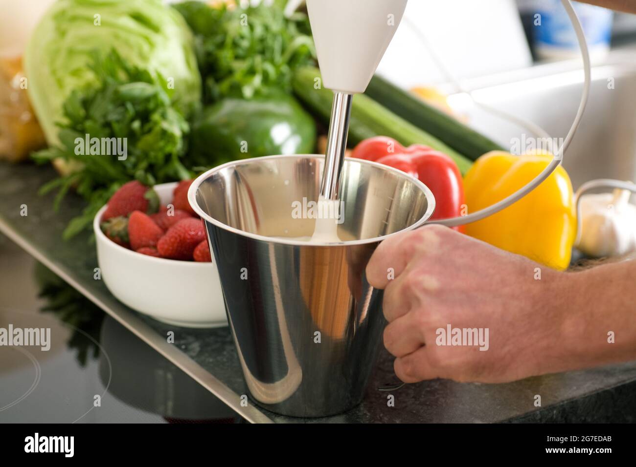 Cook preparing cream using a kitchen mixer Stock Photo - Alamy