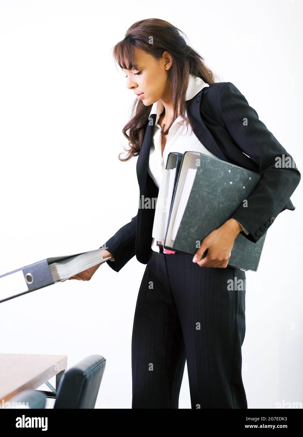 A business woman bringing files, putting them on the conference table ...