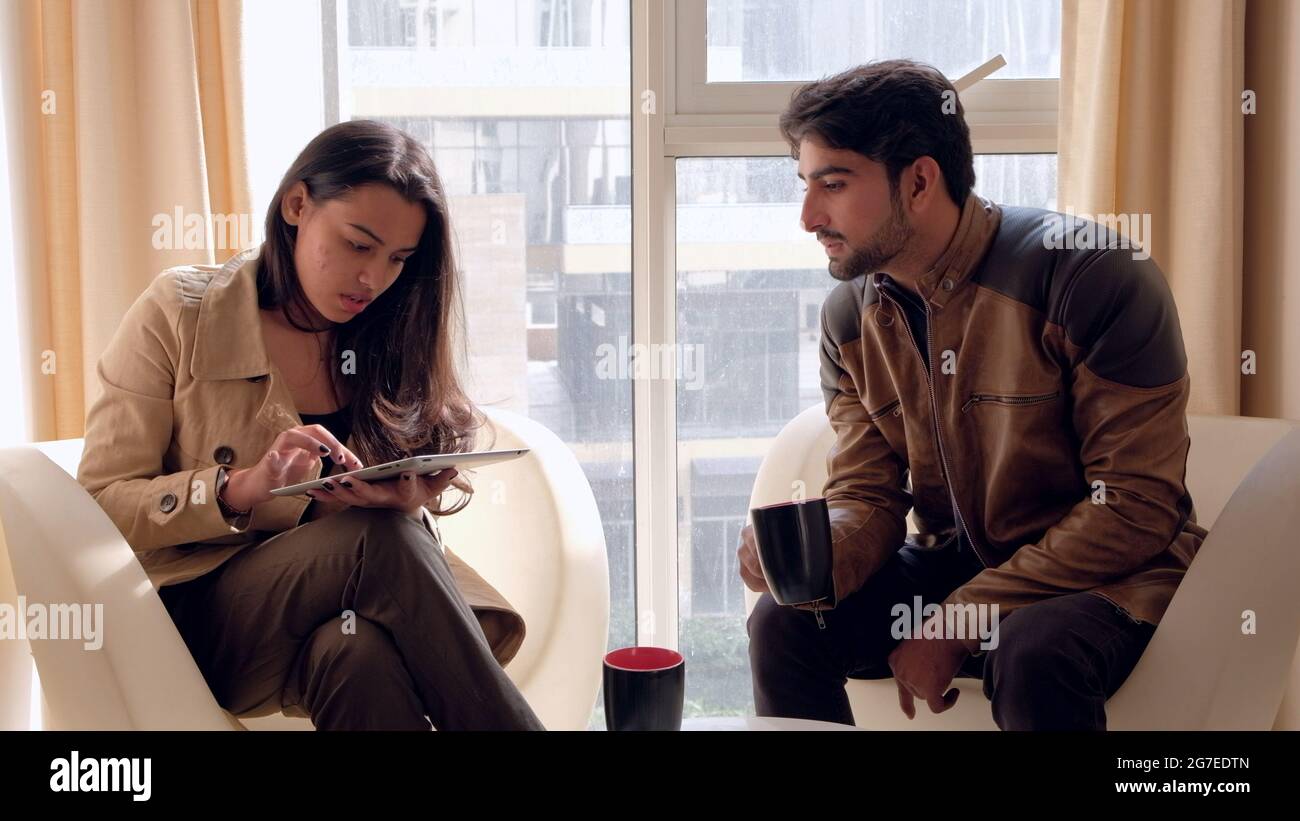 View of a man and a woman at an apartment during the day looking at ...