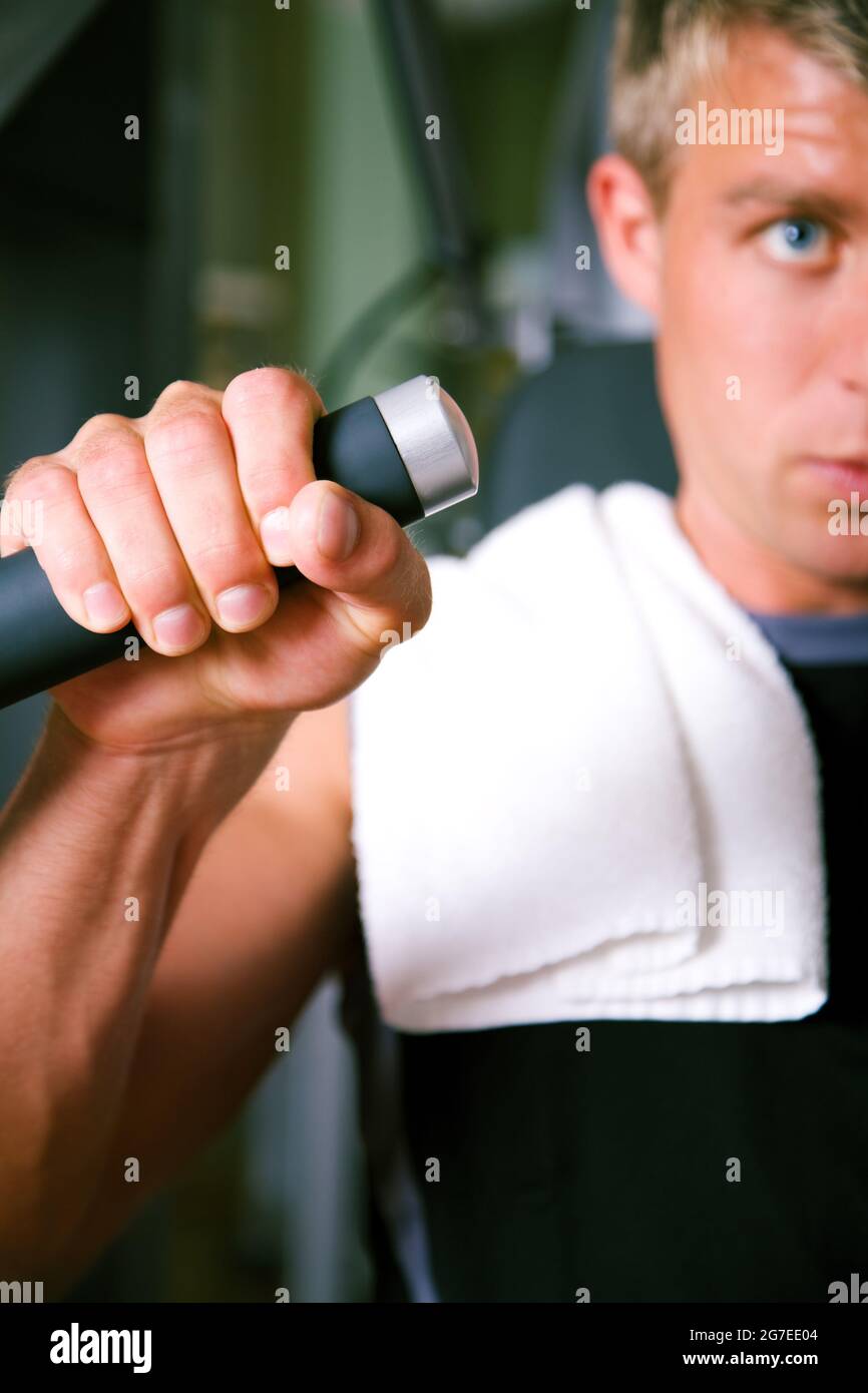 Man lifting weights in a gym, closeup on his hand Stock Photo - Alamy