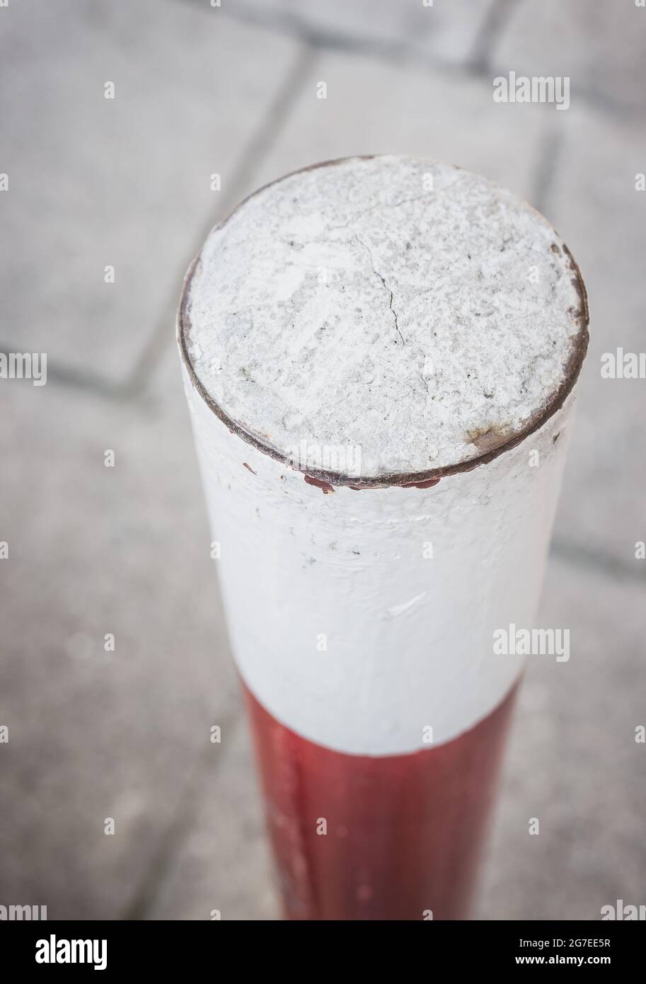Selective closeup of a white and red concrete pillar in the street ...