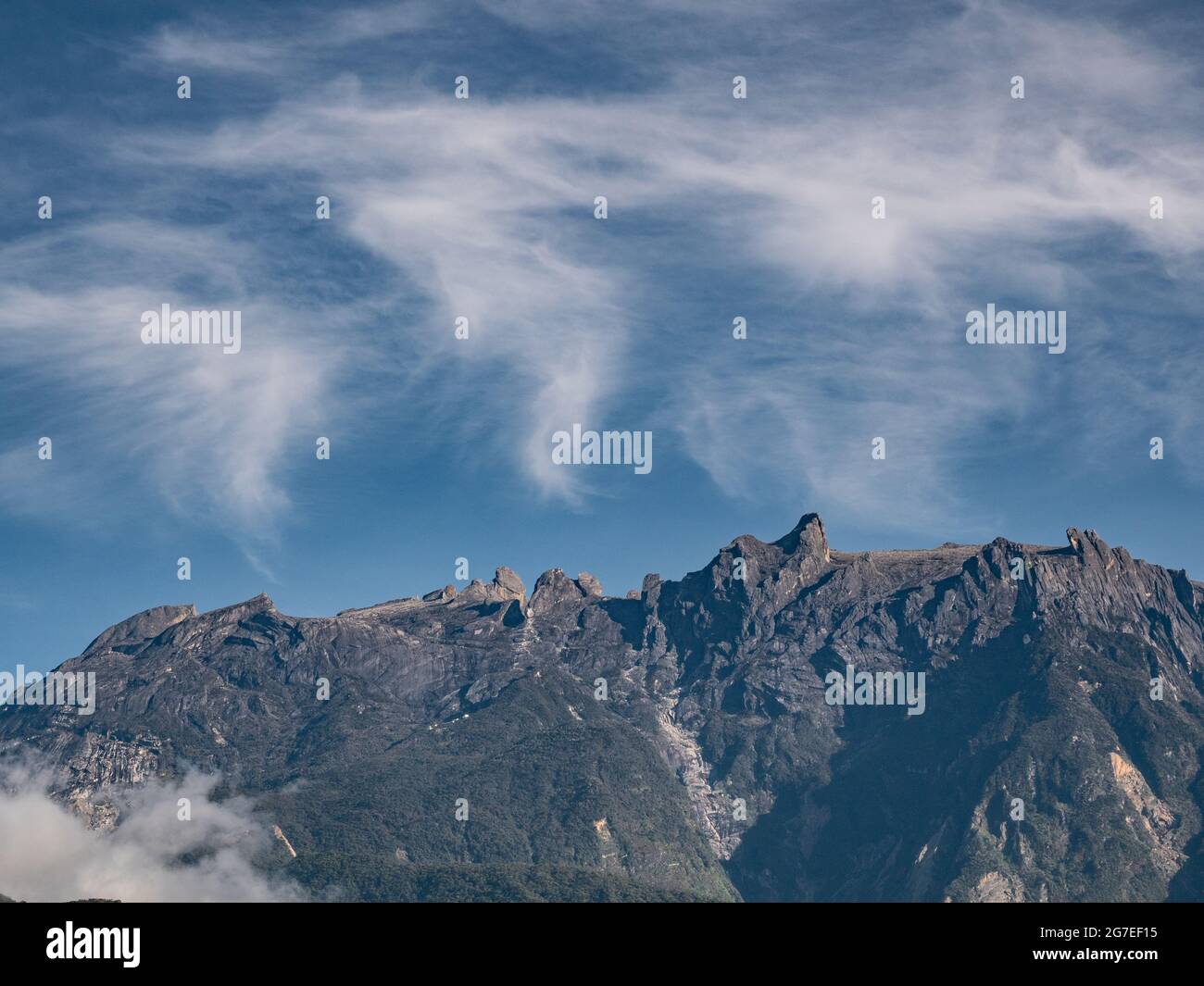 Scenery of the cloudy sky over a rocky mountain range of Kinabalu ...