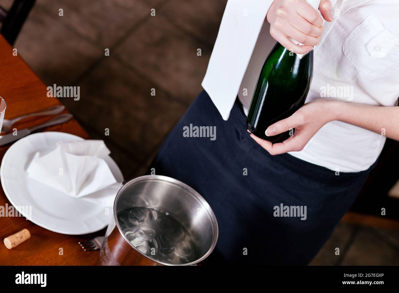 Waitress - only hands to be seen - with Champagne in restaurant Stock ...