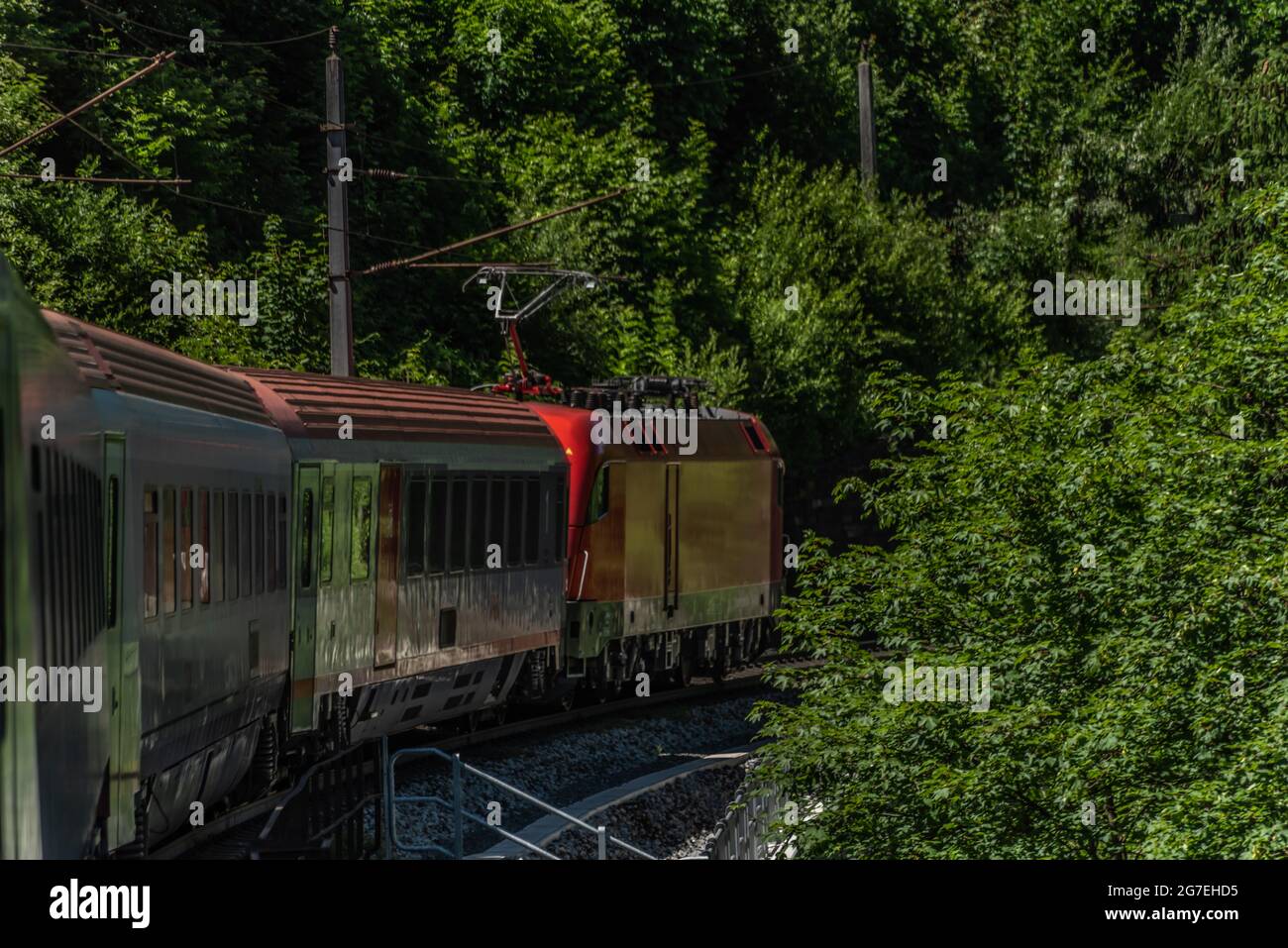 Fast red train in Austria mountains in hot color summer day Stock Photo ...
