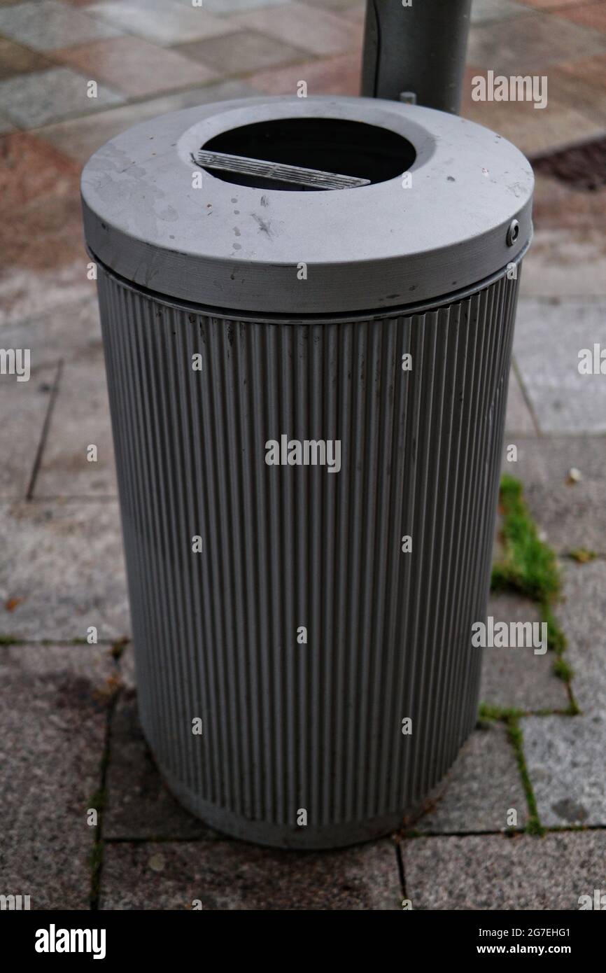 Vertical shot of an metal outdoor trash ban in a park Stock Photo - Alamy