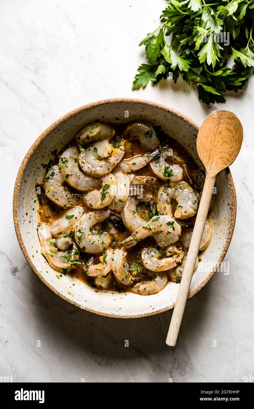 Shrimp in a homemade marinade, on a marble background Stock Photo - Alamy