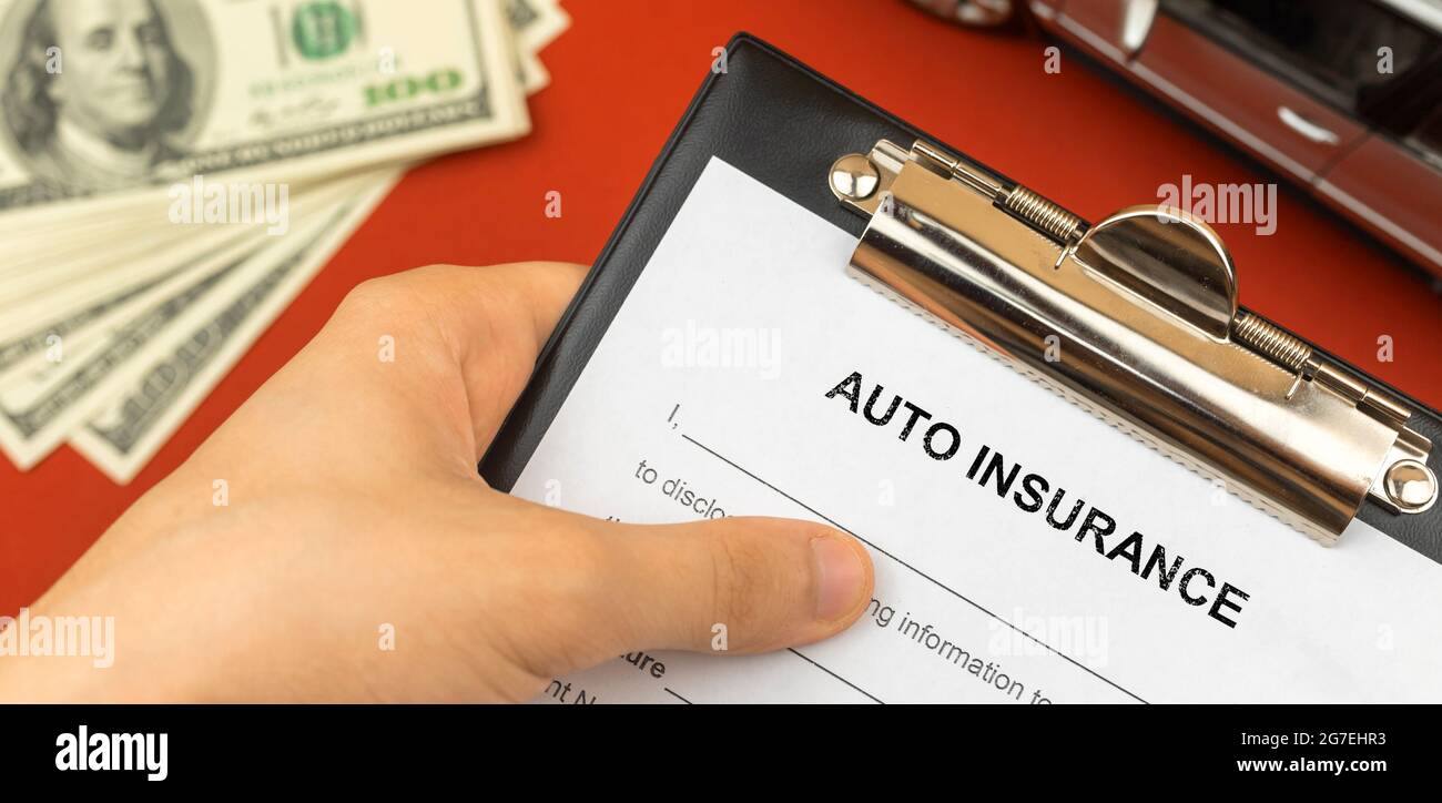 Auto and vechile insurance form in hand of man agent. Background of ...