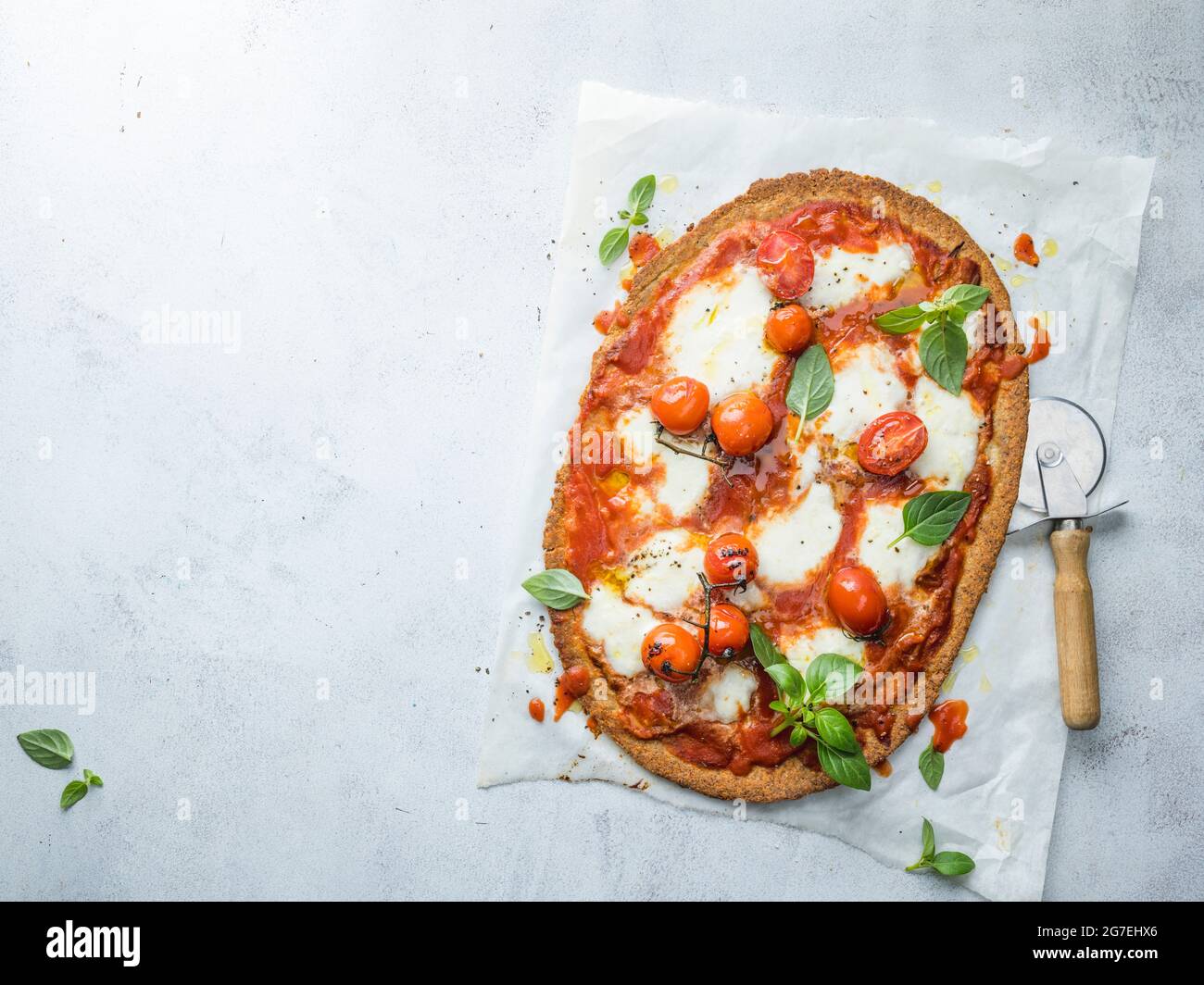 Tomato, Basil, Pizza with slicer and copy space Stock Photo - Alamy