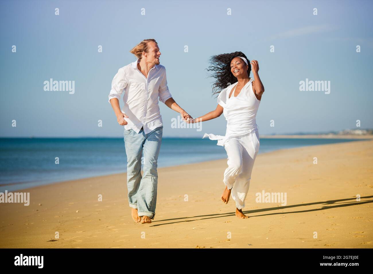 Couple - black woman and Caucasian man - walking and running down a ...