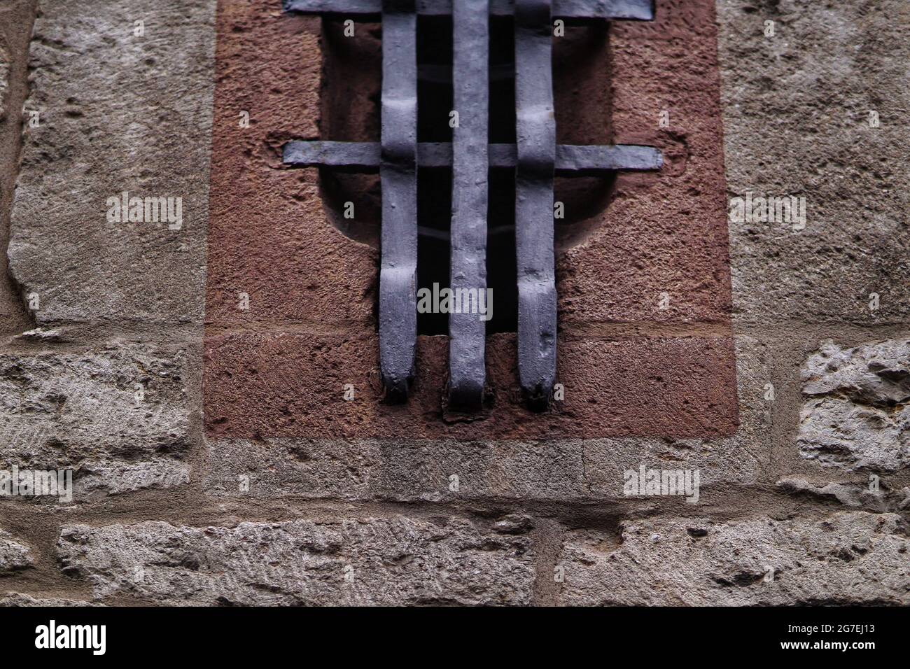 Low angle shot of a heavy metal bar on the window in a stone wall Stock ...