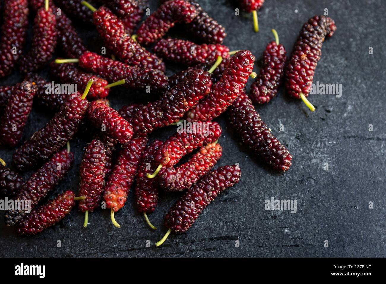 Fresh ripe Mulberries on dark background Stock Photo - Alamy