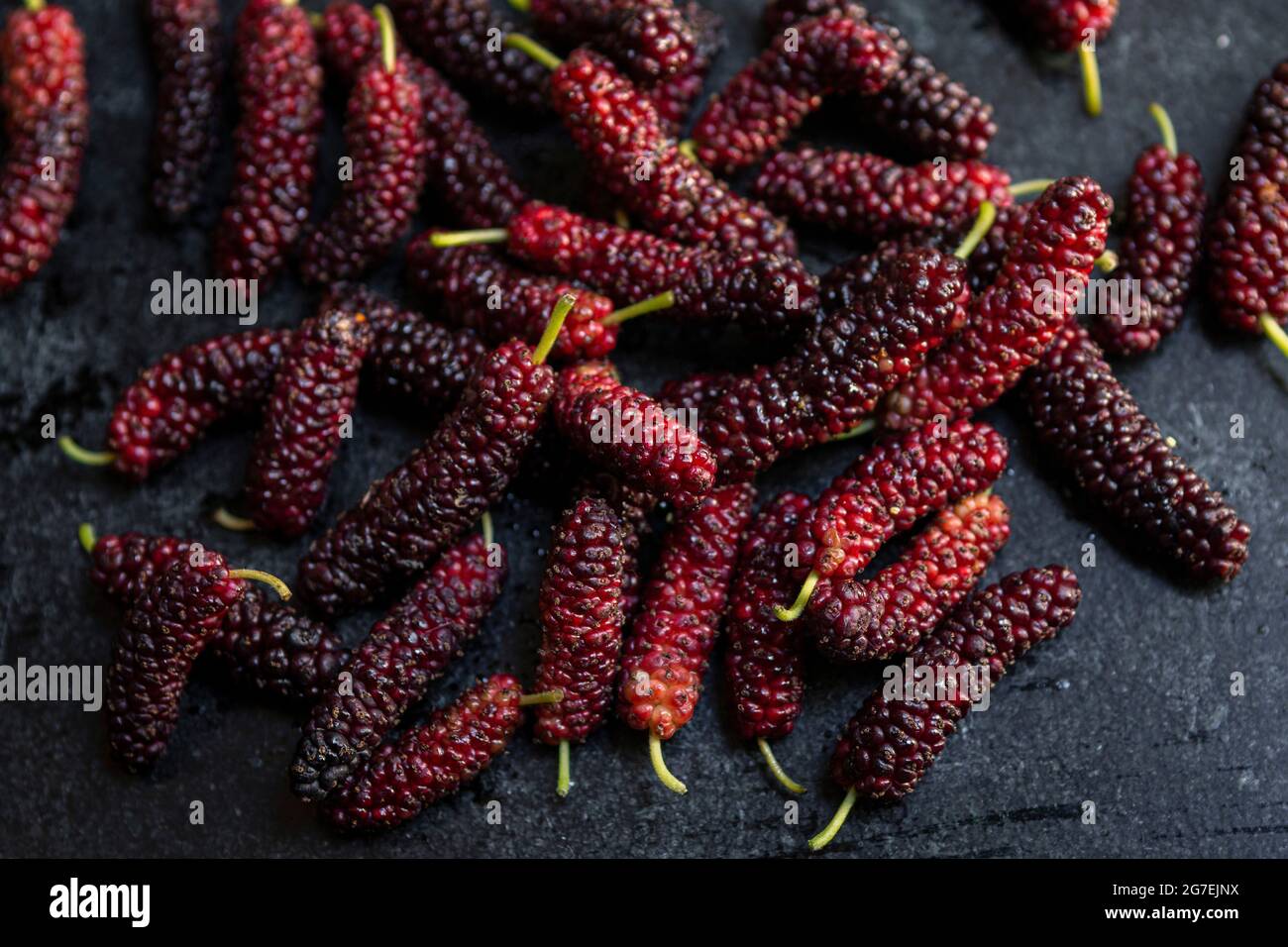 Fresh ripe Mulberries on dark background Stock Photo - Alamy