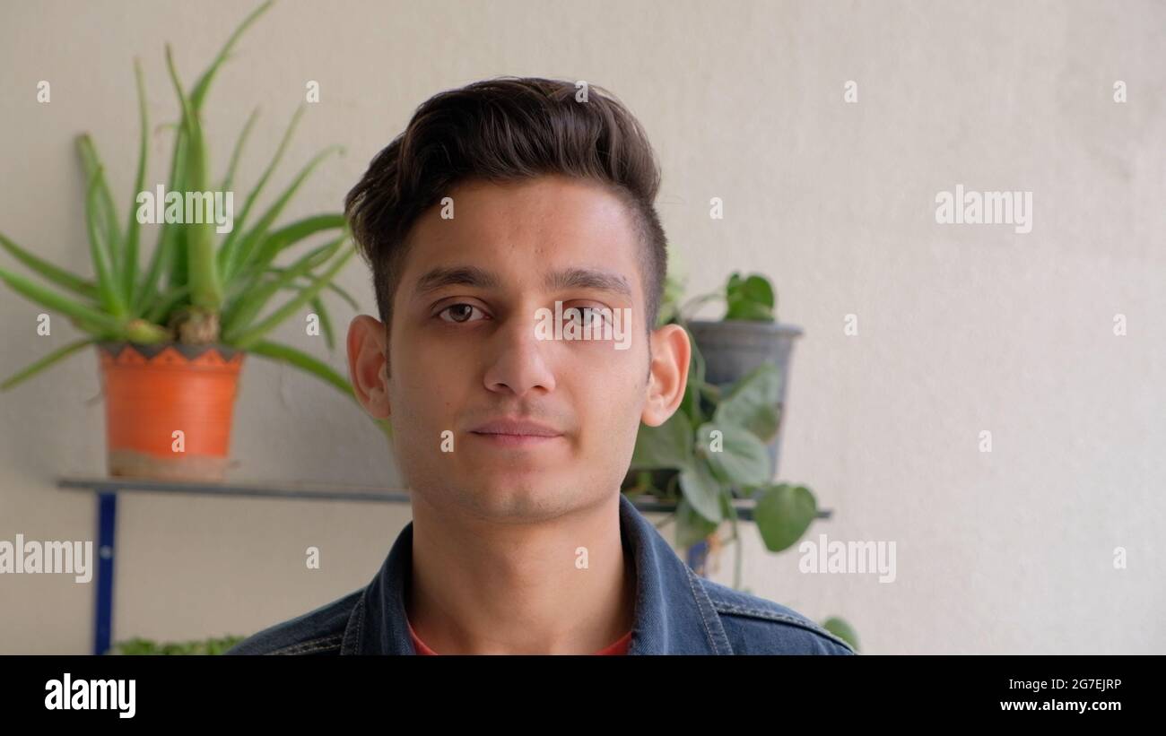 Handsome young Indian male looking at something with a serious face and ...