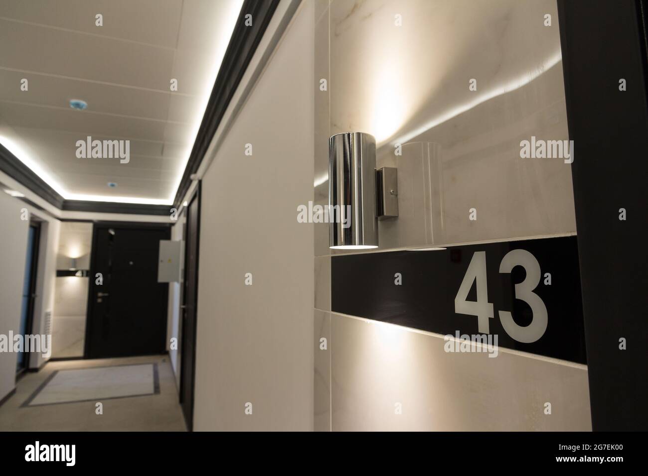 Hotel corridor with apartment number. Closed doors in the hallway ...