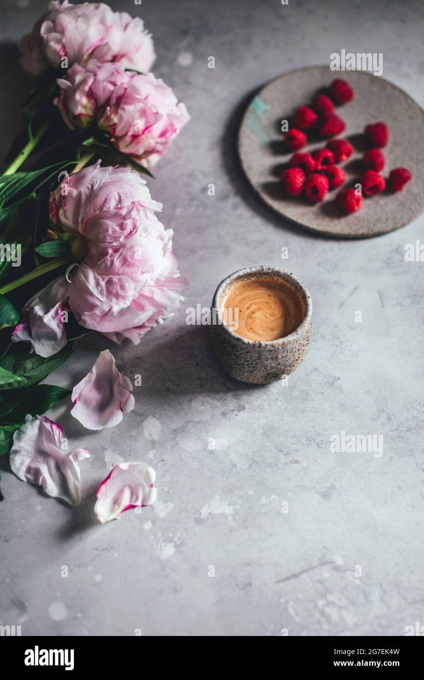 Cup of coffee on grey background with flowers Stock Photo - Alamy