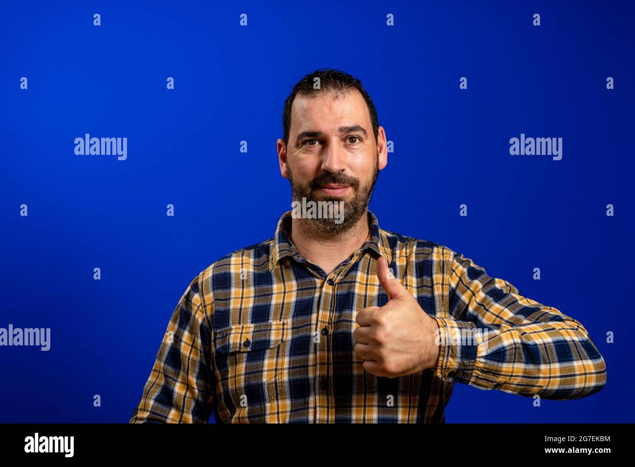Happy man giving thumbs up sign like hands gesture. Hipster male with ...