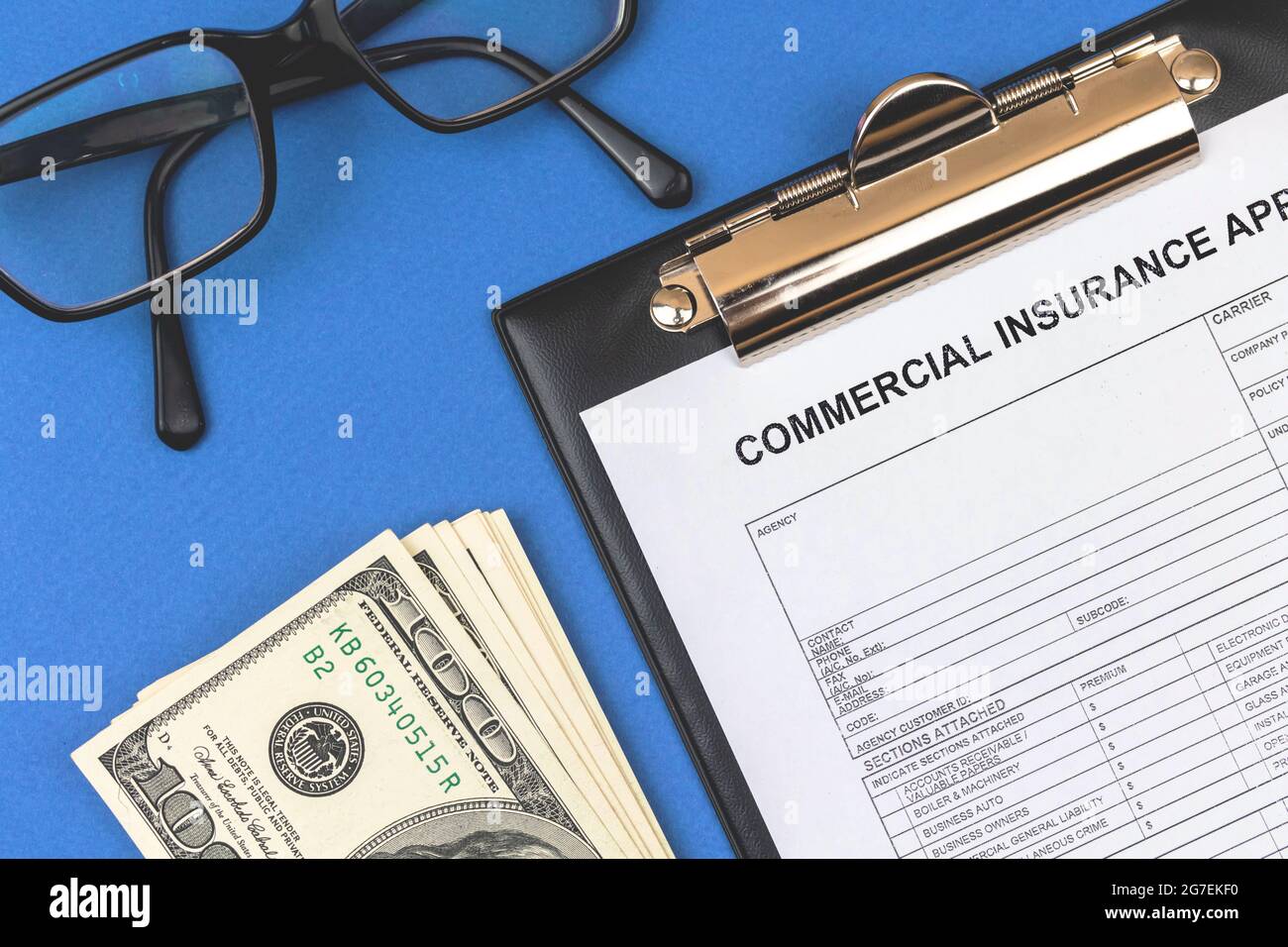 Commercial insurance claim form. Office desk with official contract and ...