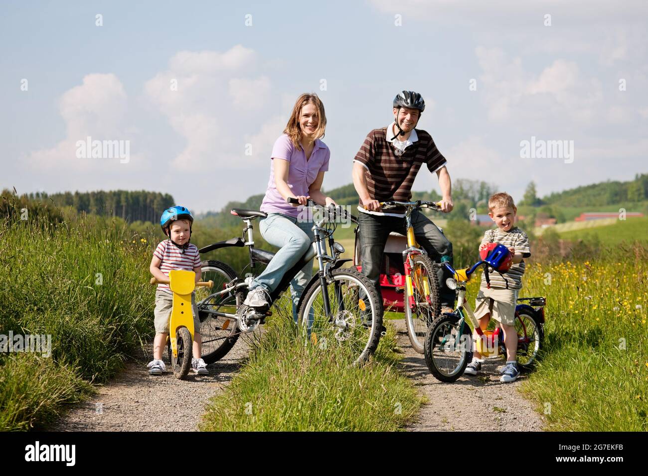 Family with two children having a weekend excursion on their bikes on a ...