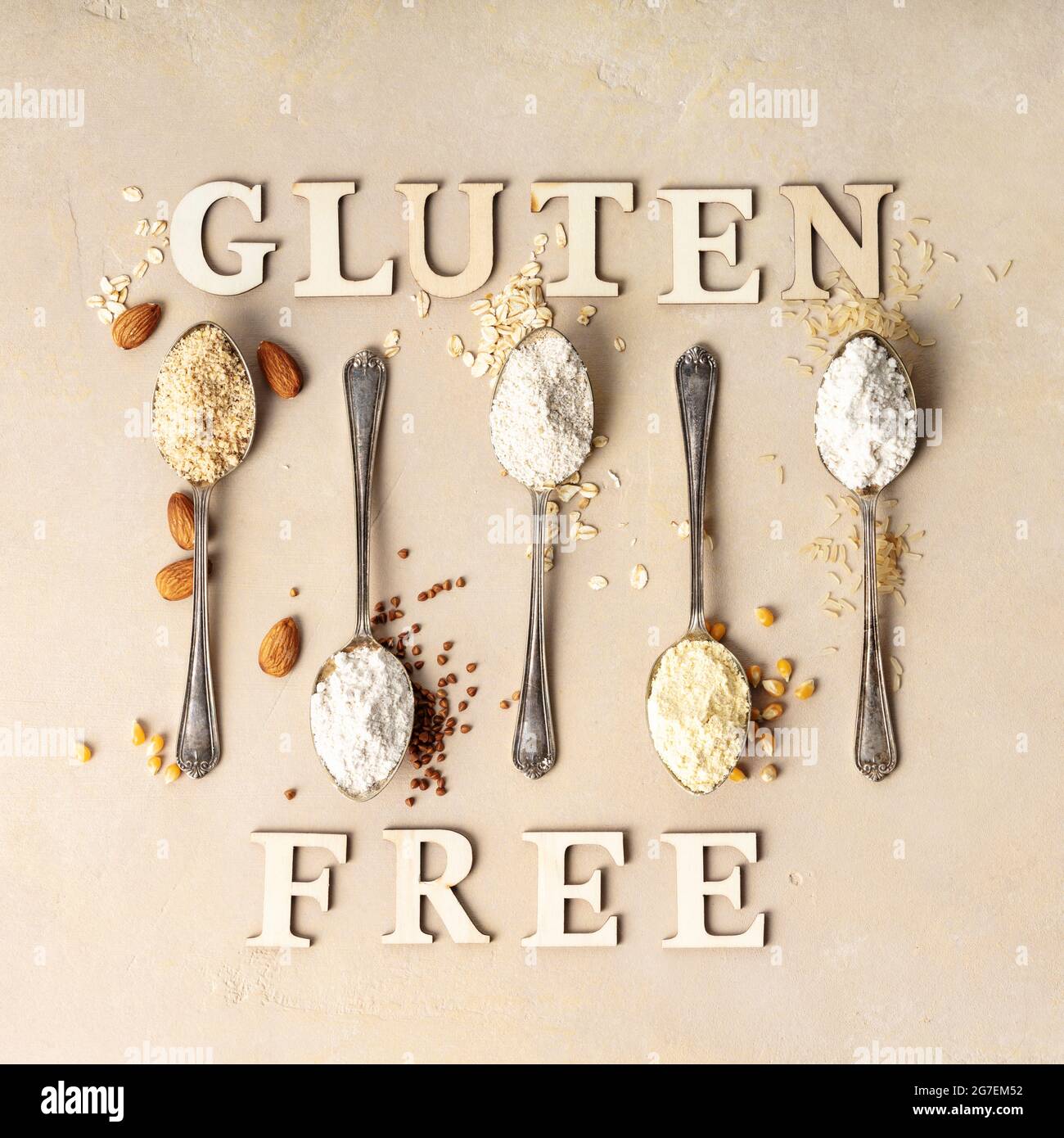 Metal spoons of various gluten free flour (almond flour, oatmeal flour ...