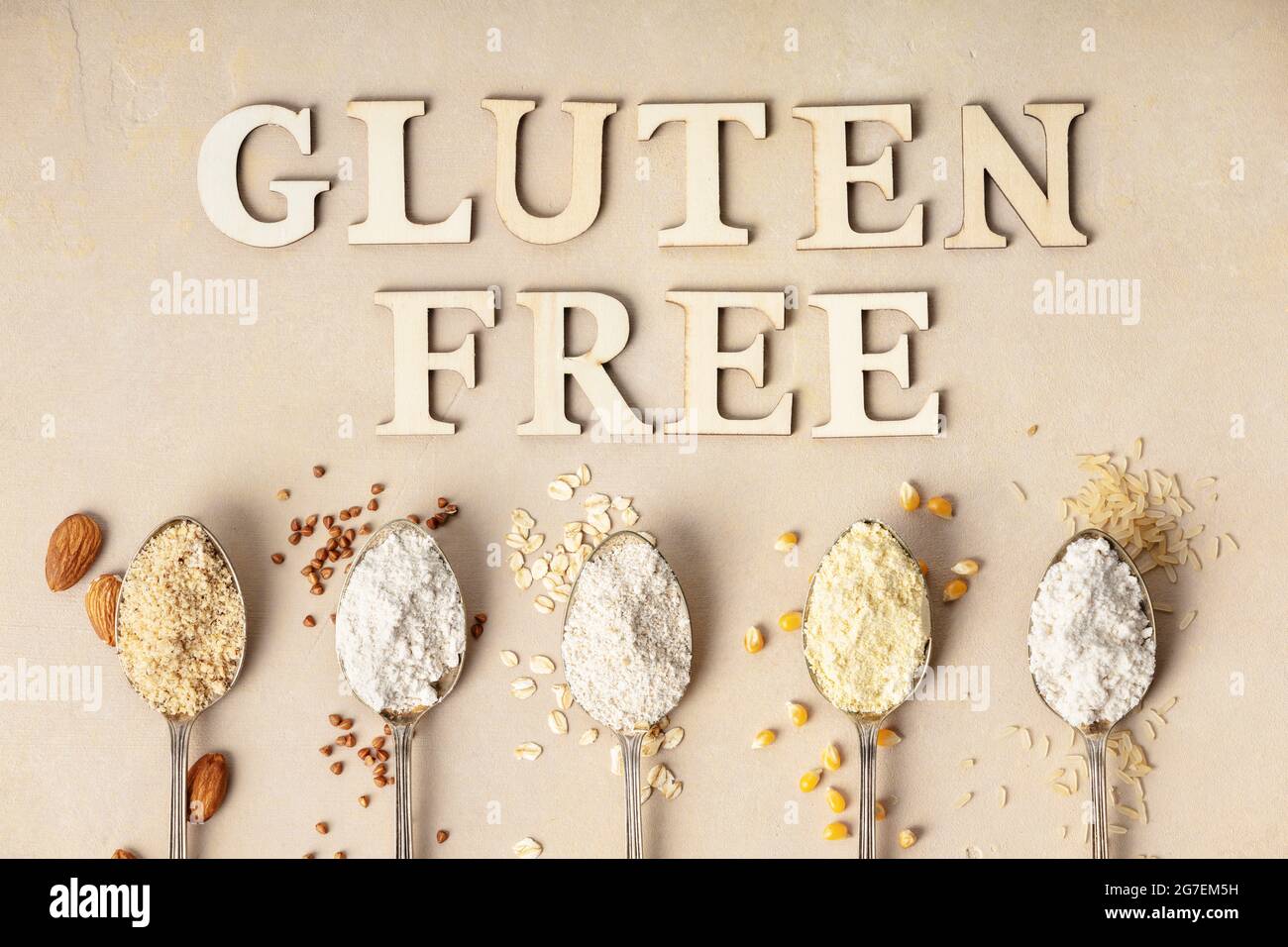 Metal spoons of various gluten free flour (almond flour, oatmeal flour ...