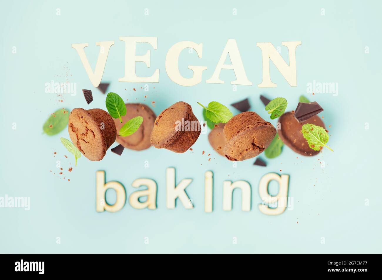 Chocolate muffins with mint leaves and chocolate pieces on blue ...