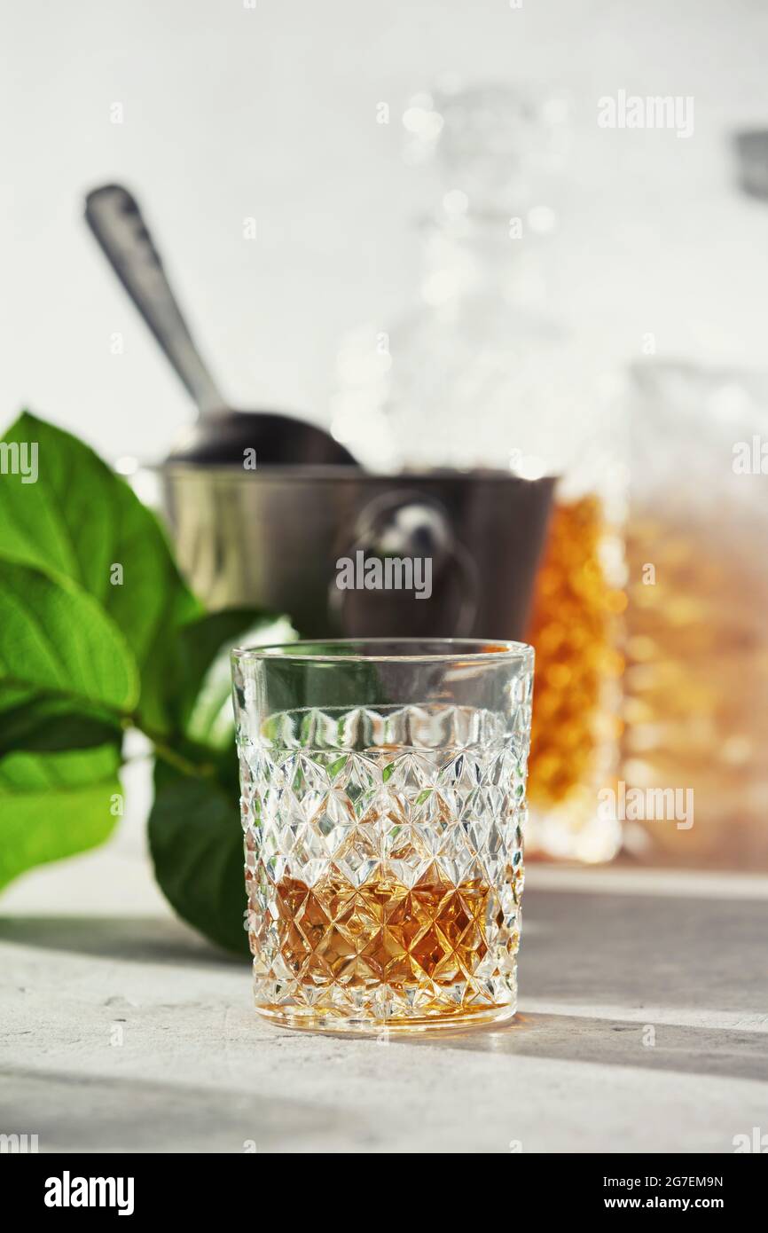 Whiskey with ice close up. Grey stone background Stock Photo - Alamy