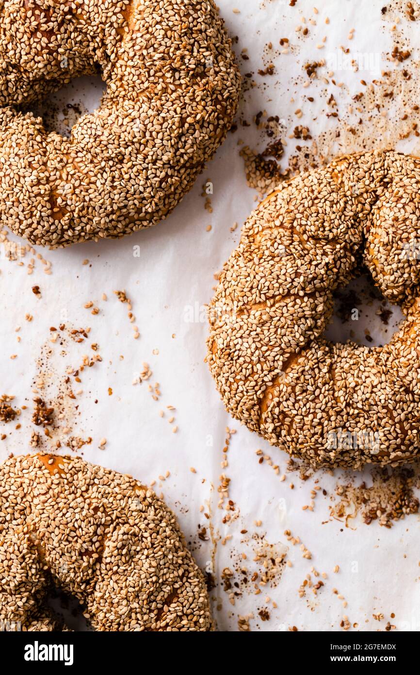 Simit Bread covered with sesame seeds on greaseproof paper Stock Photo ...