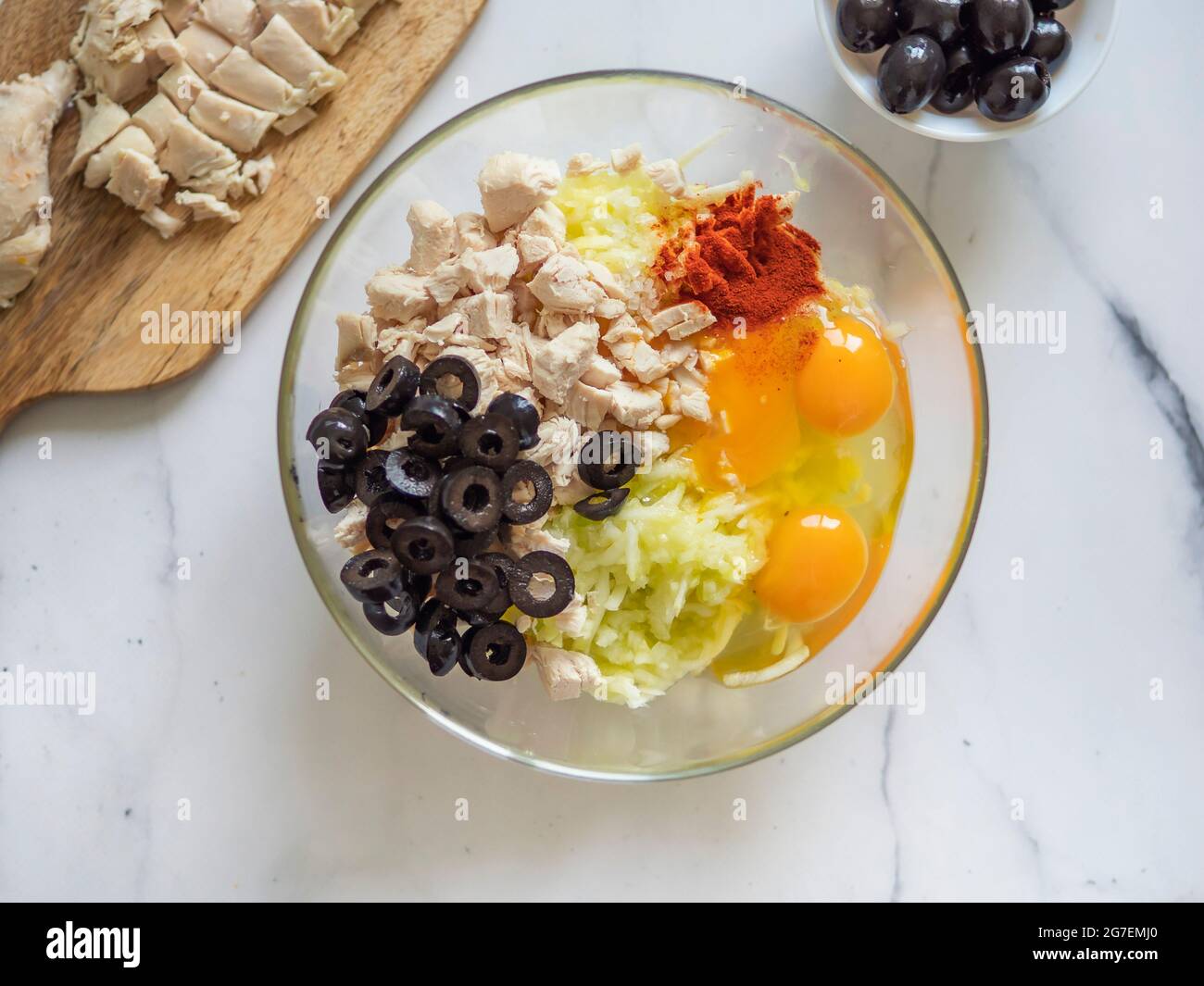 Ingredients for meat muffins in glass bowl over marble tabletop ...