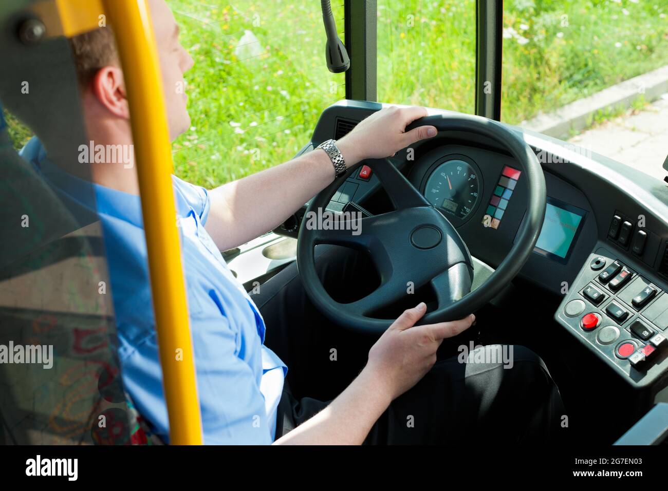 Bus driver sitting in his bus on tour Stock Photo - Alamy