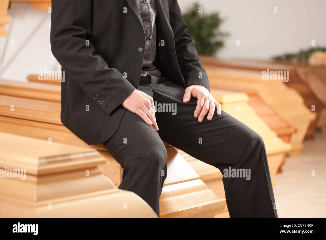Undertaker in his store with a display of coffins Stock Photo - Alamy