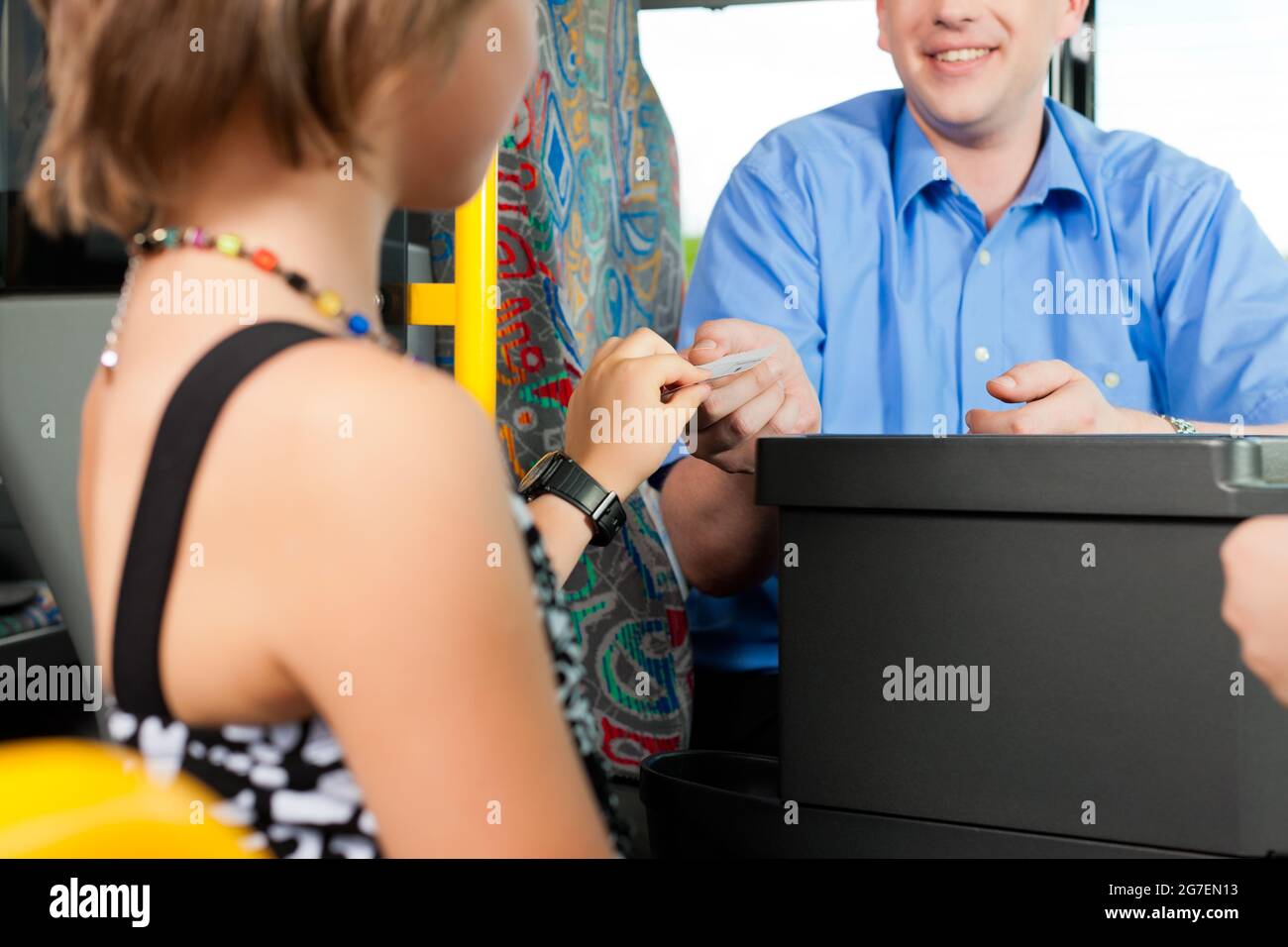 Child boarding a bus and buying a ticket Stock Photo - Alamy
