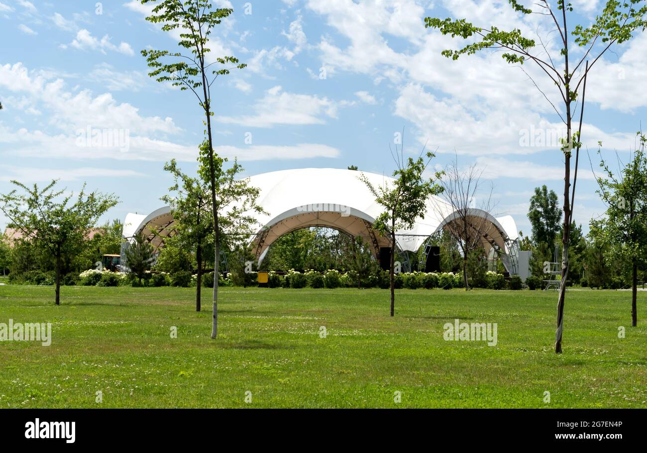 A white tent for celebrations in a lovely green glade, decorated with ...
