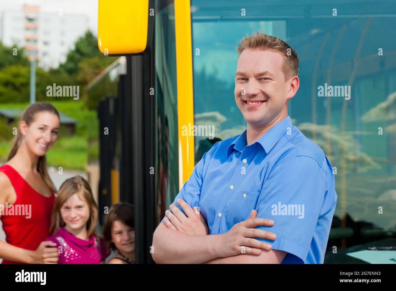Passengers boarding a bus at a bus station; in the foreground a bus ...