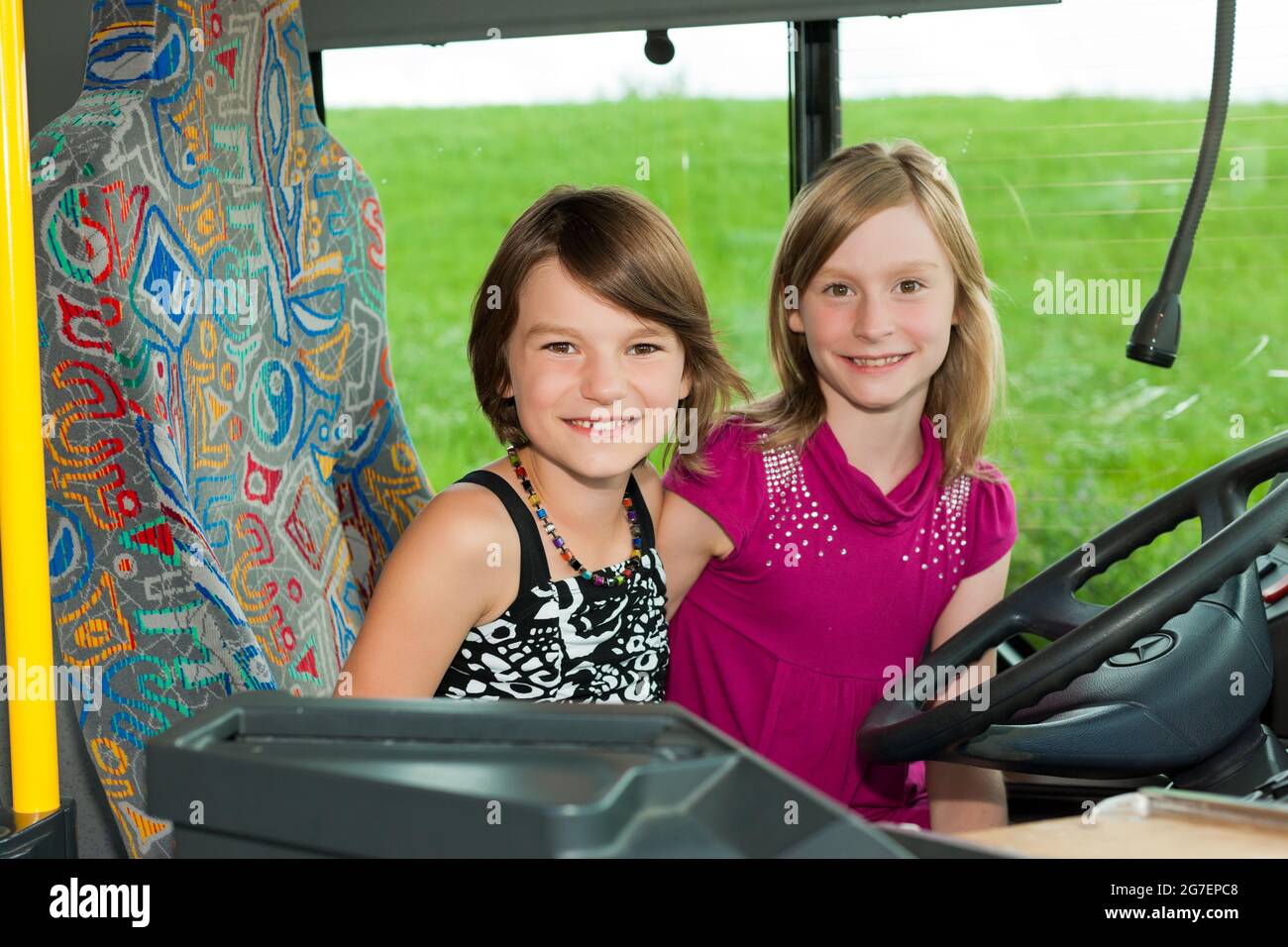 Children sitting in a bus like they were drivers Stock Photo - Alamy