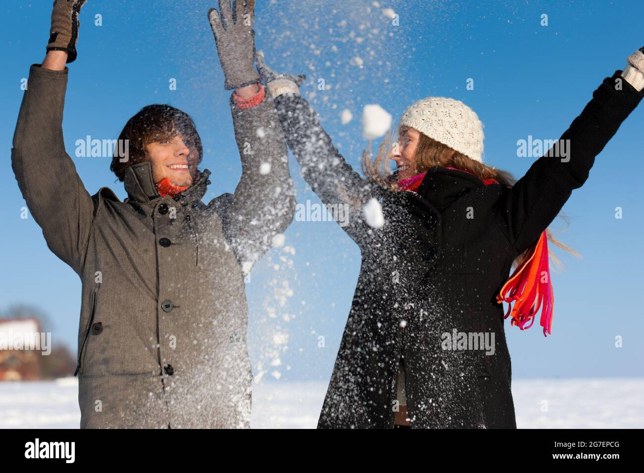 Smiling girlfriend throwing snow hi-res stock photography and images ...