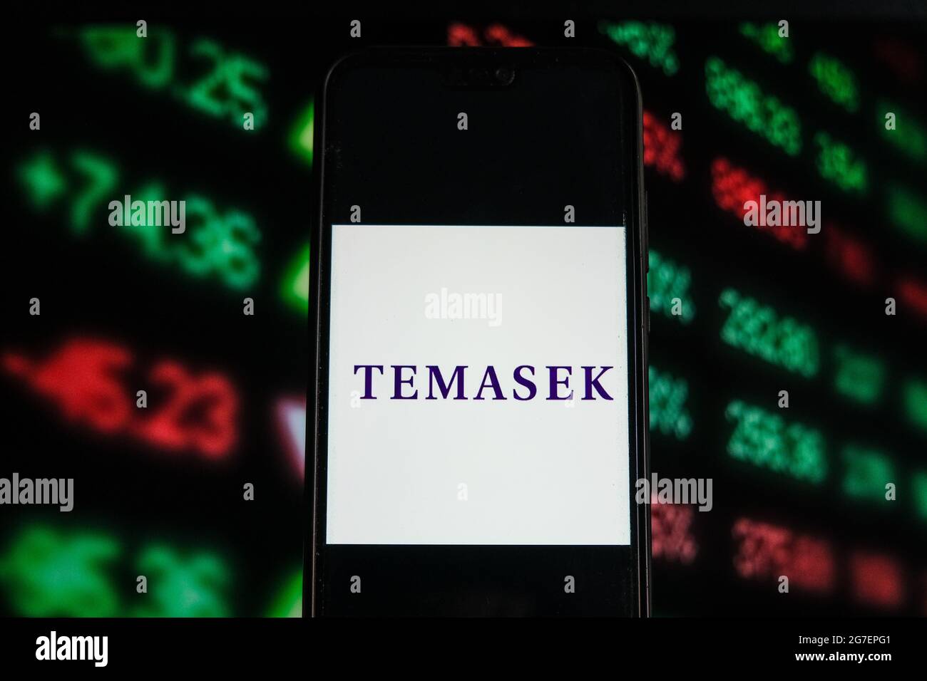 In this photo illustration a Temasek logo is seen displayed on a ...