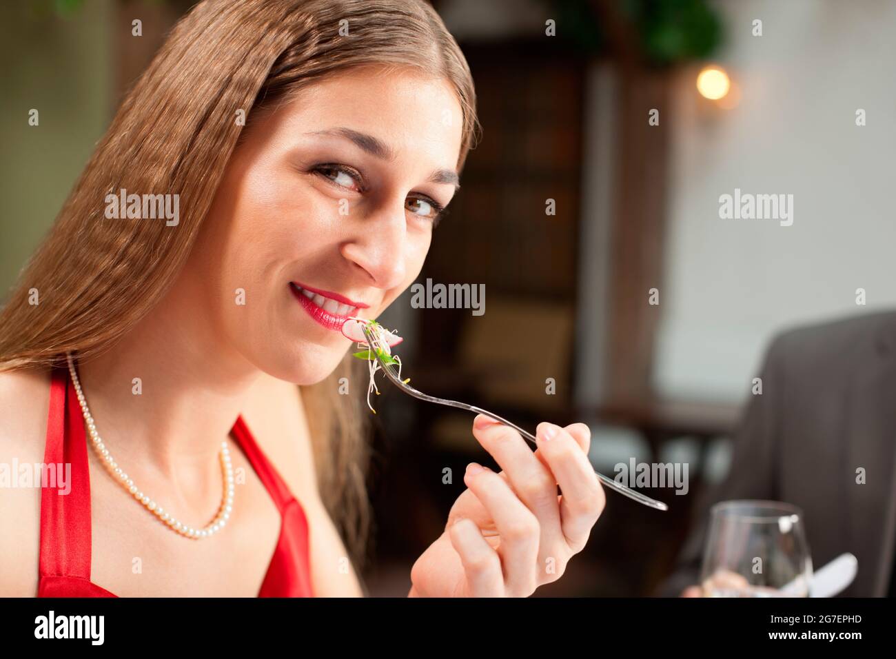 Portrait of a beautiful woman eating at a restaurant Stock Photo - Alamy