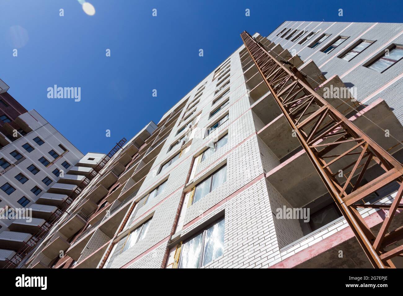 Lifting mechanisms at a construction site. Elevator mast against the ...
