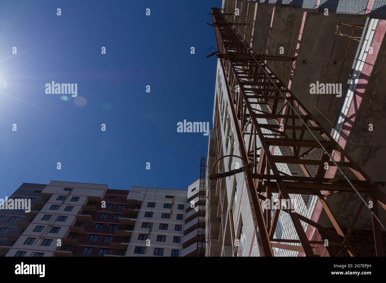 Lifting mechanisms at a construction site. Elevator mast against the ...