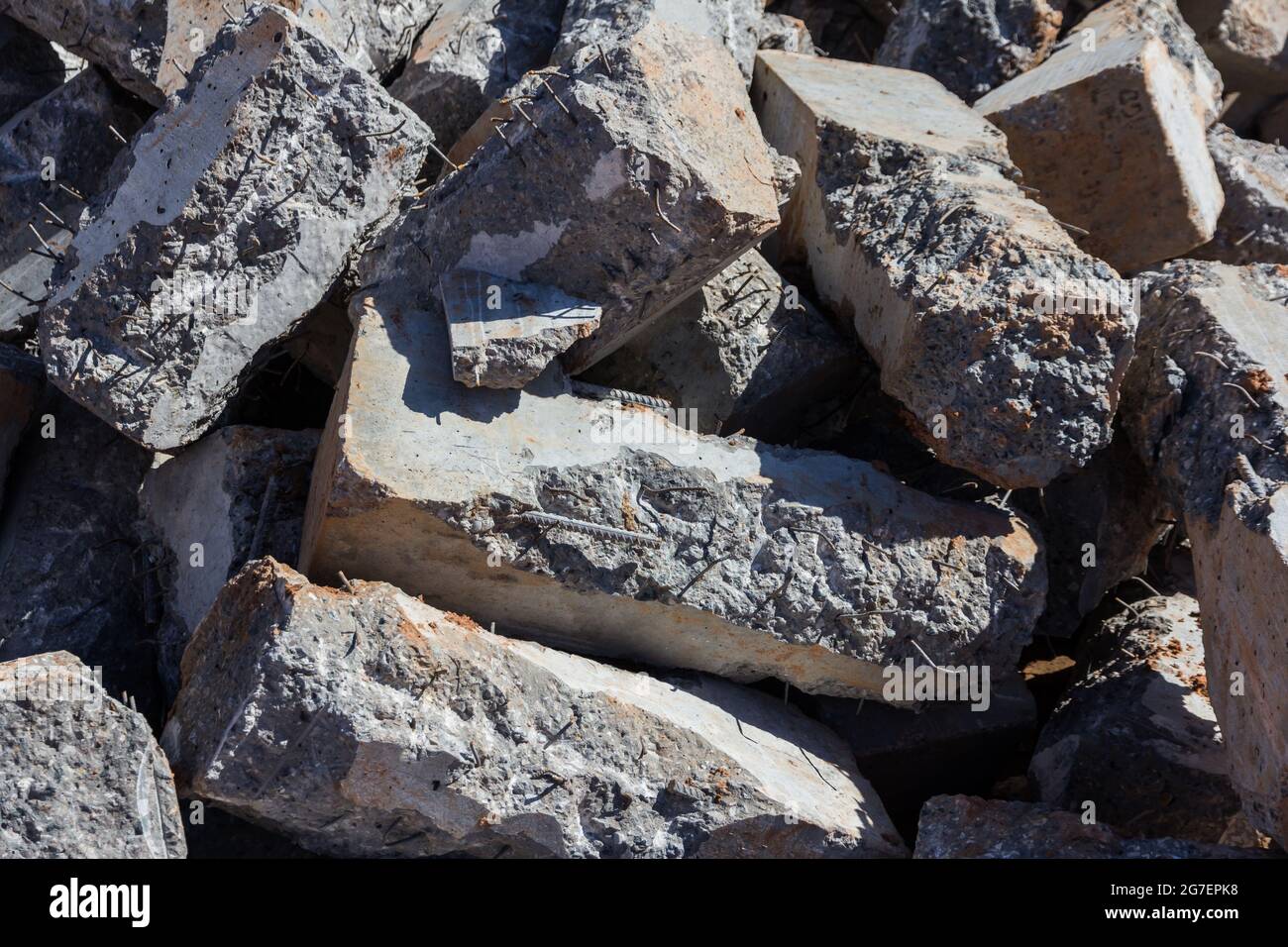 Broken concrete pillars. Fragments of used broken concrete ...